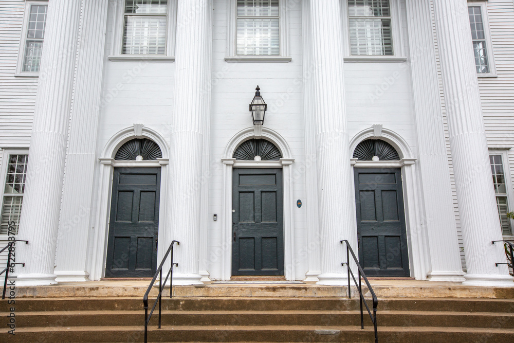 Front of Cheshire town church building with staircase and three black ...