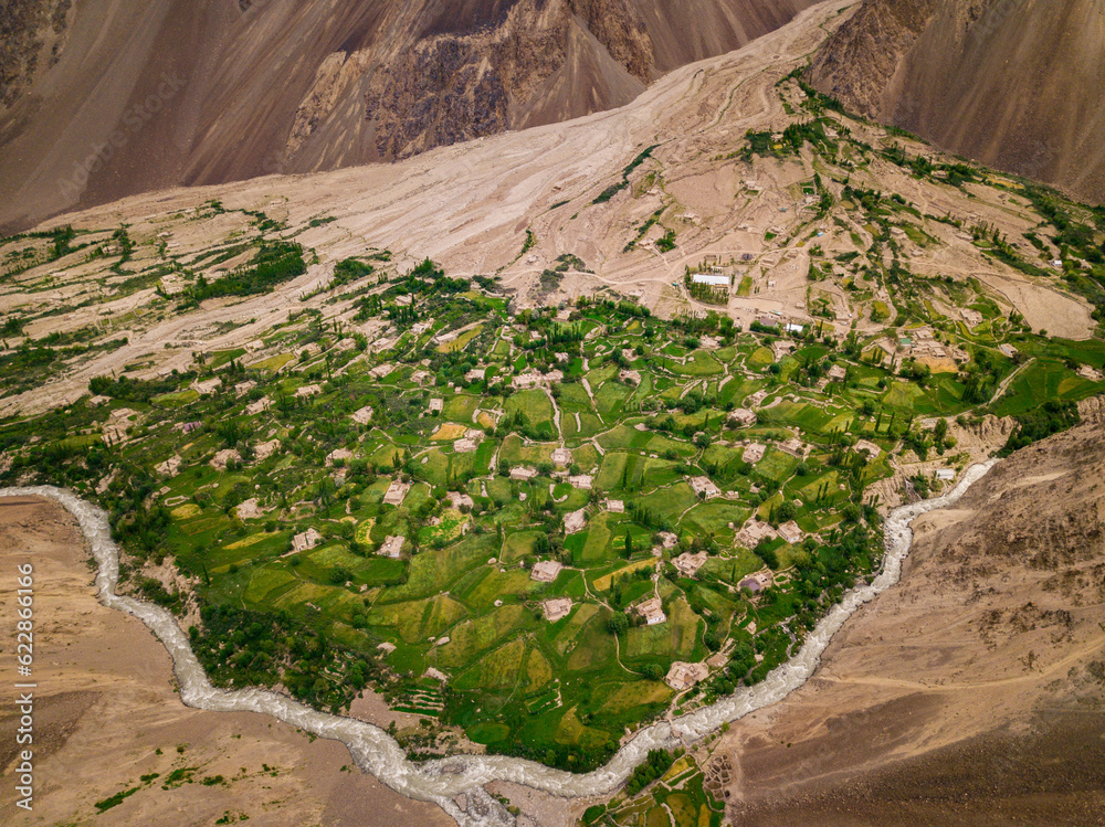 Aerial view of lush village with fields and trees in a landslide delta ...
