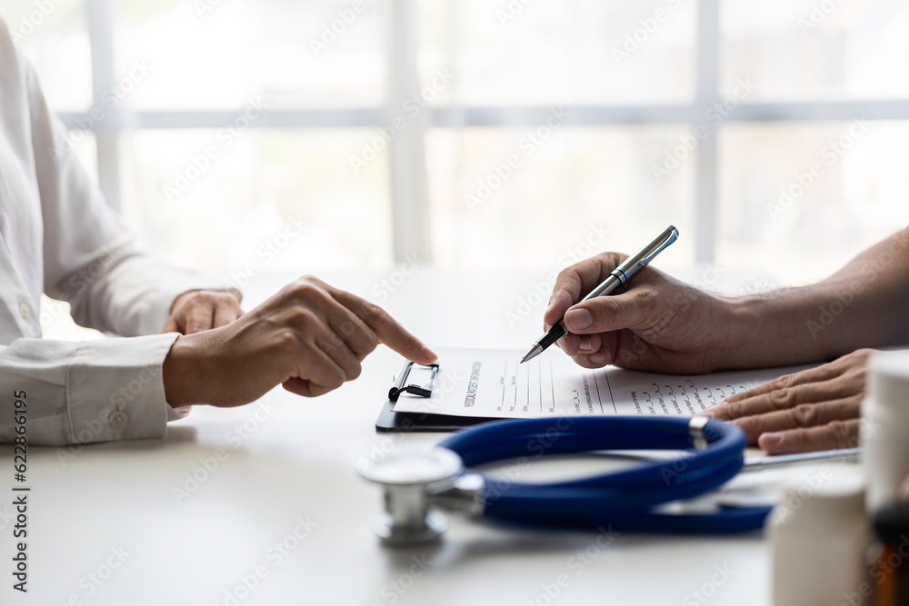 An Asian female patient visits and discusses health problems with a ...