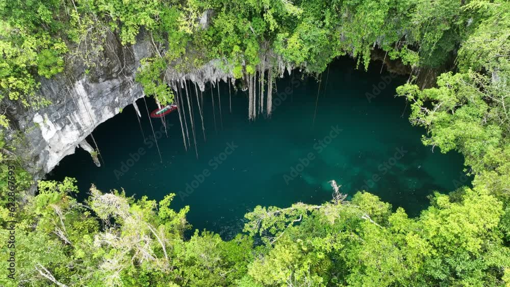 Ocean water fills a collapsed cave on a remote, jungle-covered island ...