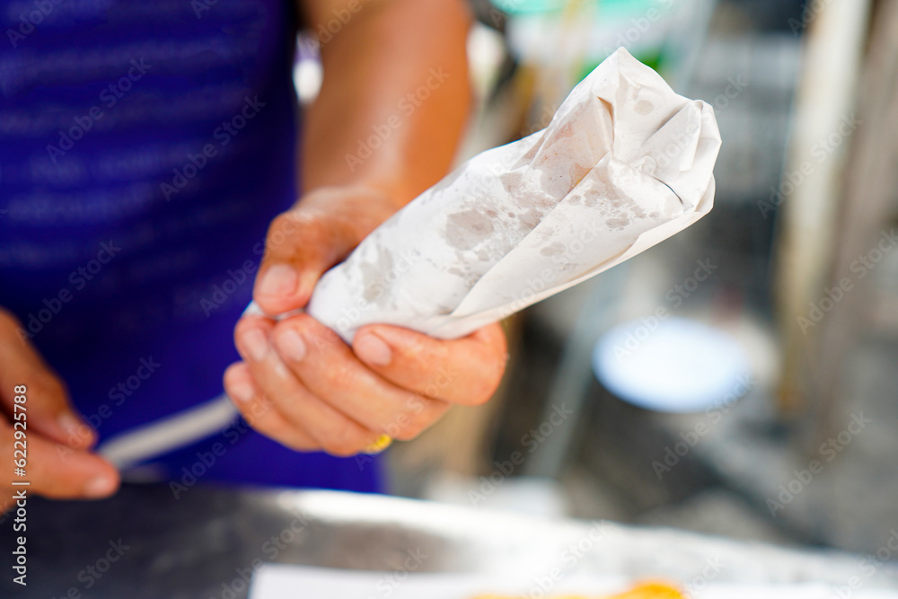 The picture shows the finished wrapped roti ready to be sold to the ...