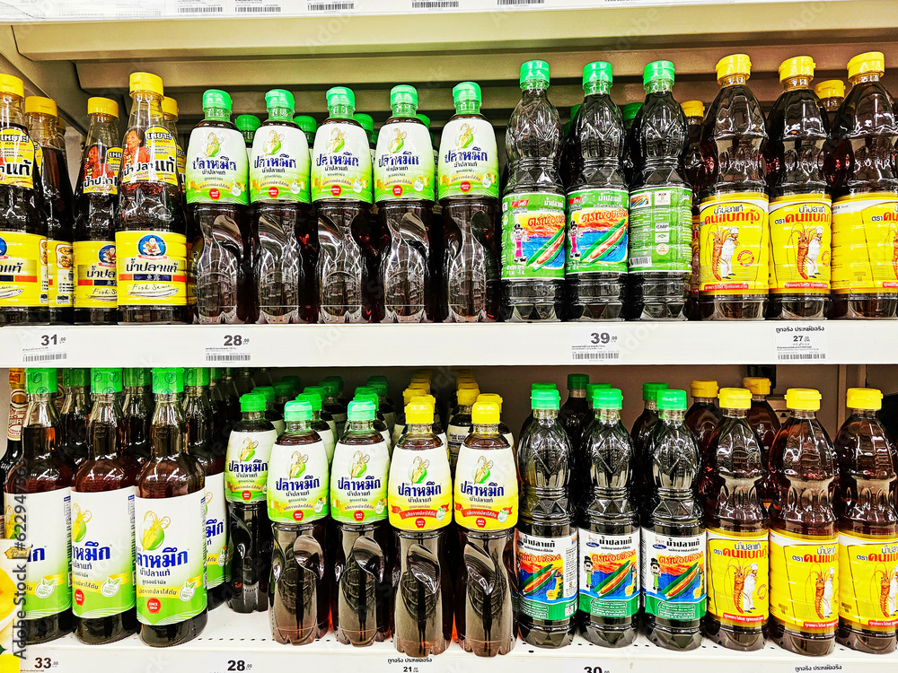 Various brands of Thai fish sauce on market shelves. Window display of ...