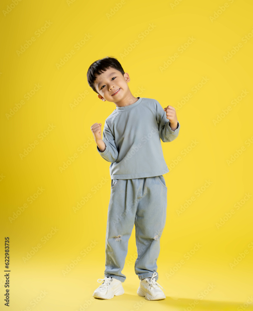 full body image of boy posing on a yellow background. Stock Photo ...