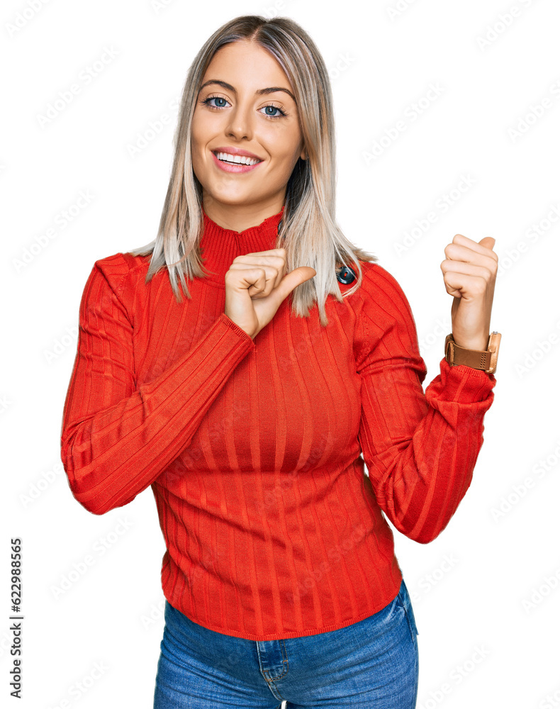 Beautiful blonde woman wearing casual clothes pointing to the back ...