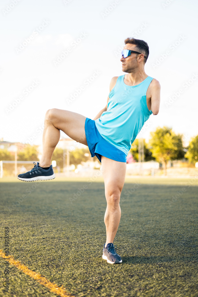 An adult soccer player with an amputated arm has one leg open to ...