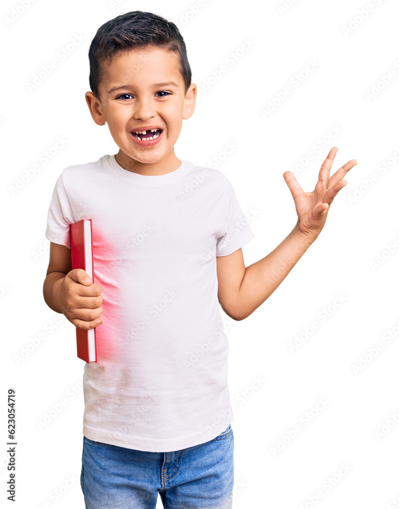 Little cute boy kid reading a book celebrating victory with happy smile ...