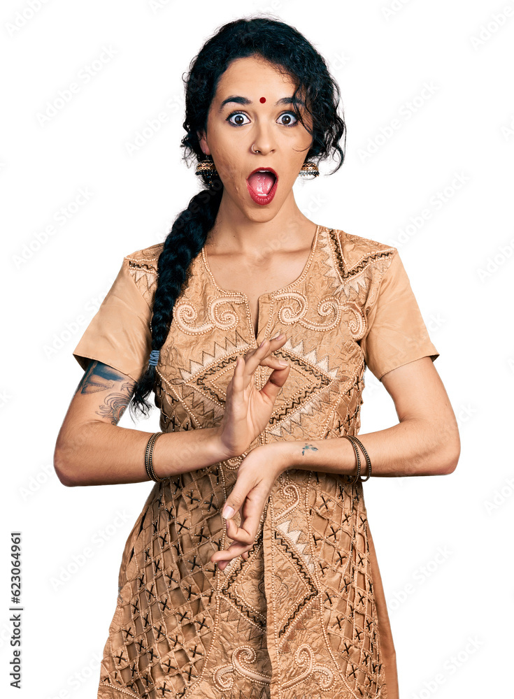 Young indian woman doing mudra with two hands afraid and shocked with ...