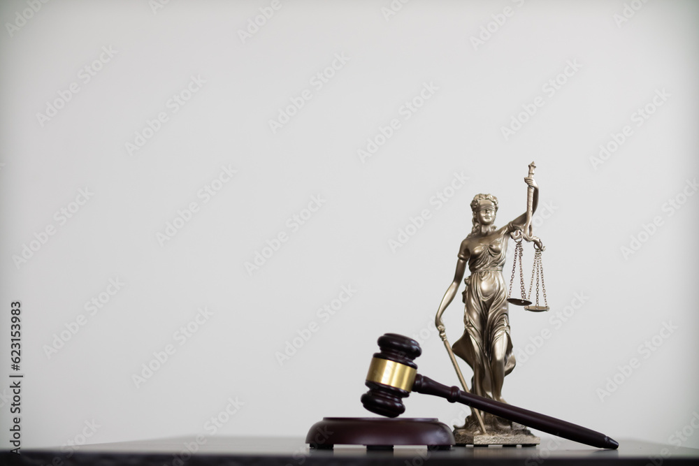 gavel wood and Brass court scales are used to decorate a table in a ...