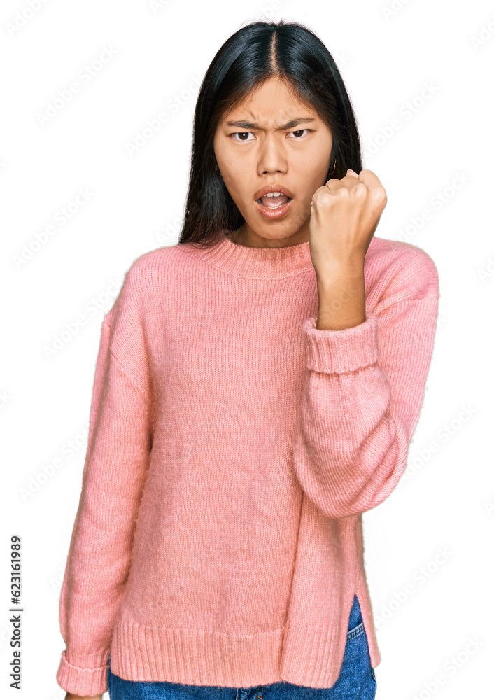 Beautiful young asian woman wearing casual winter sweater angry and mad ...
