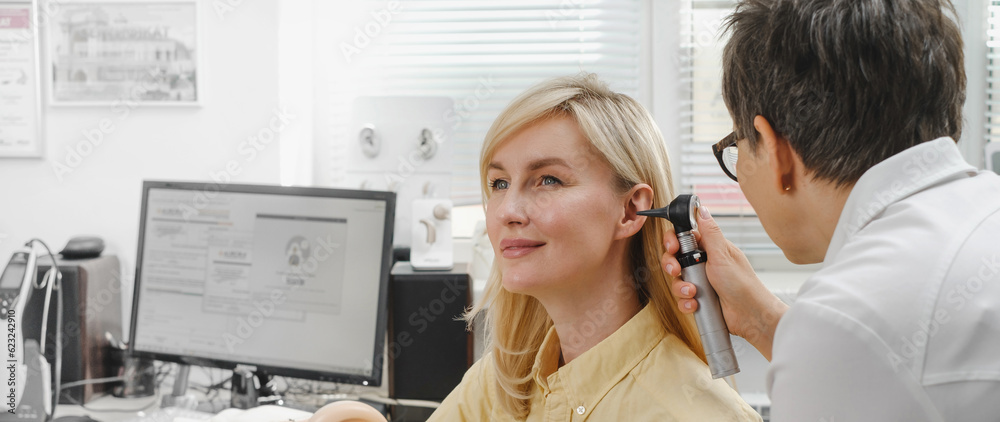 Woman patient having check-up of hearing at doctor otolaryngologist ...