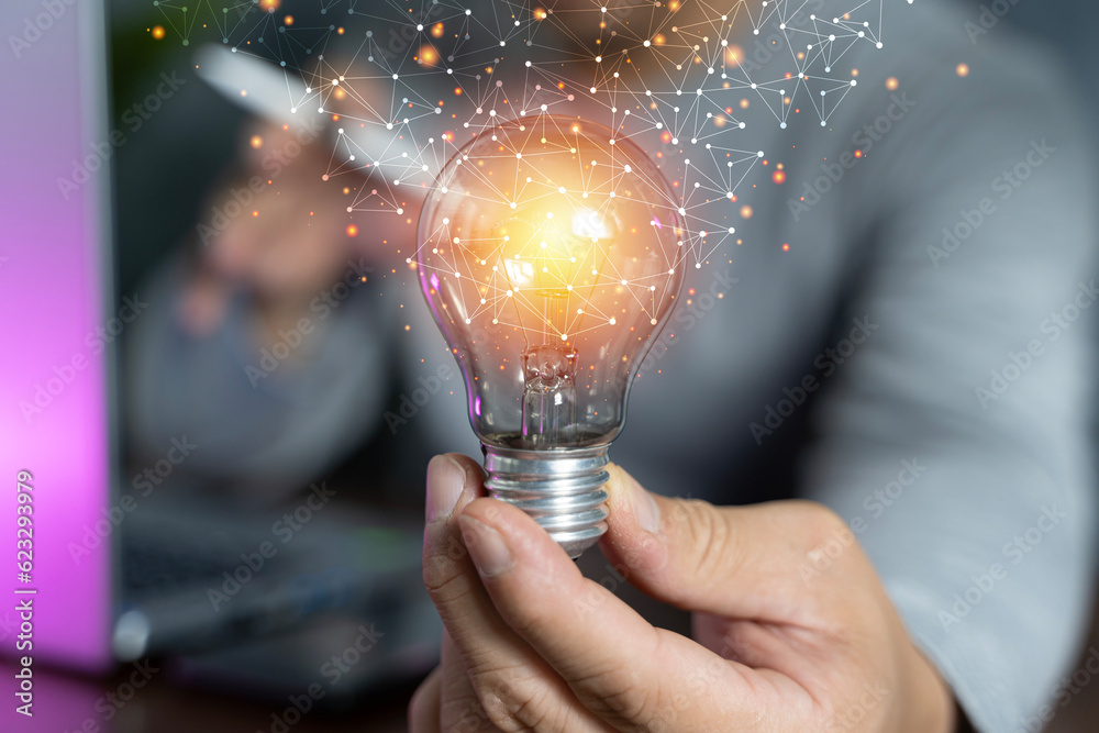 Crop close up of businessman sit at desk hold light bulb inspired by ...