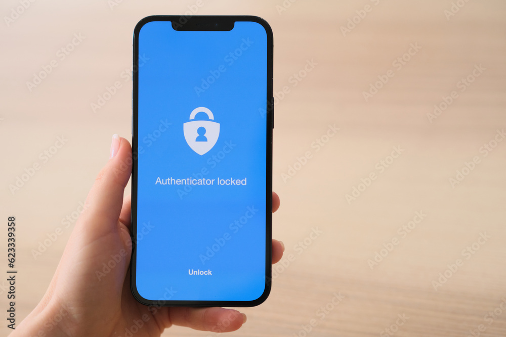Foto de Hand holds smartphone with Microsoft Authenticator app logo on ...