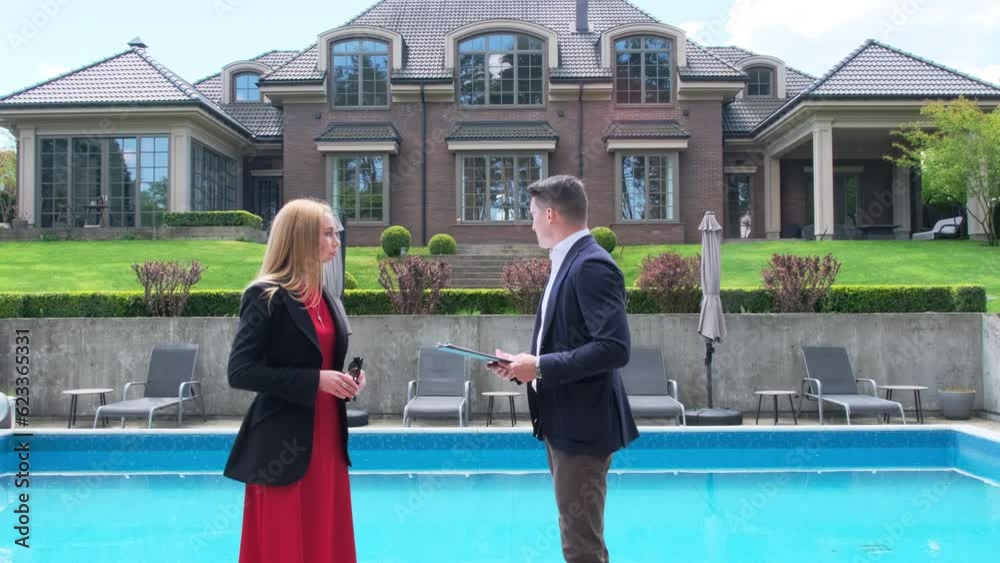 Businesswoman and real estate agent inspect swimming pool of summer ...