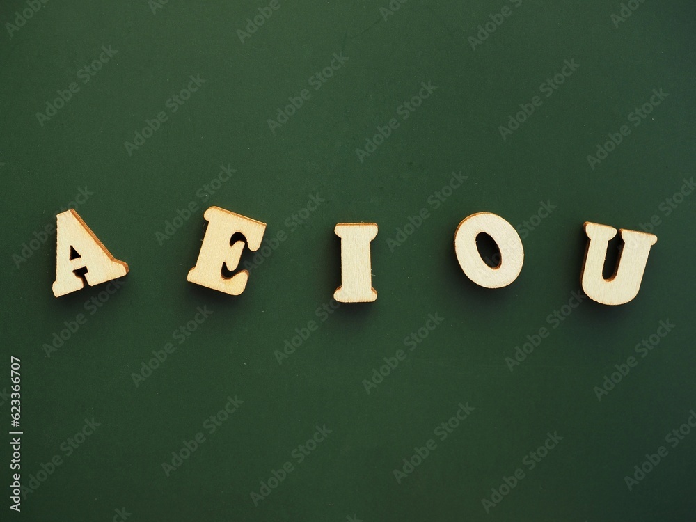 Aeiou uppercase vowels on a chalkboard background Stock Photo | Adobe Stock
