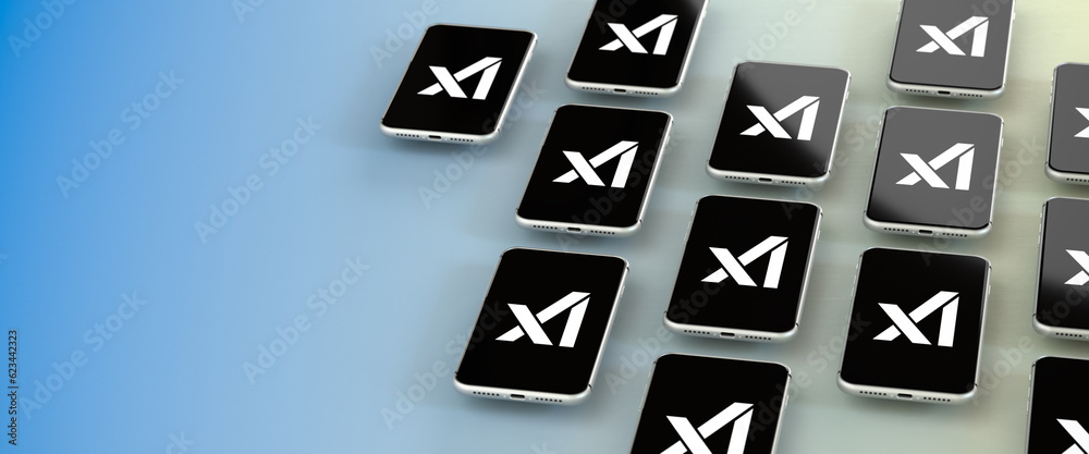 Logos of the AI startup xAI by Elon Musk on mobile phones hovering over ...