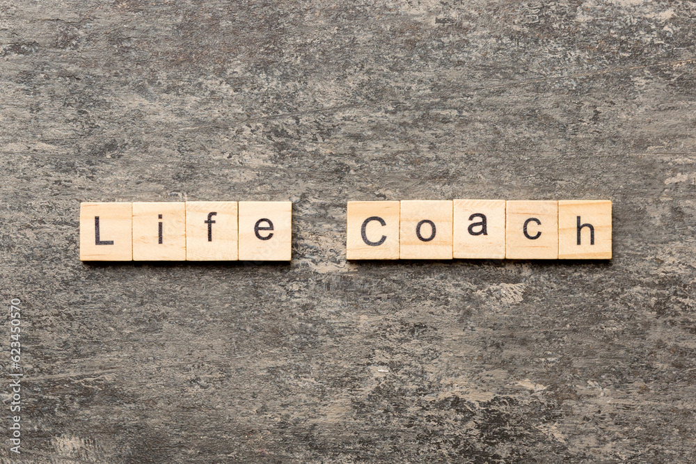 Life coach word written on wood block. Life coach text on cement table ...
