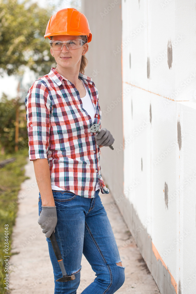 Insulation of the house with polyfoam. The worker is checking with the ...