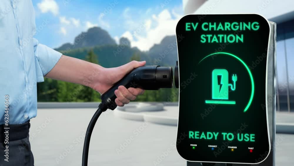 Hand pull EV charger from smart electric charging station display ...
