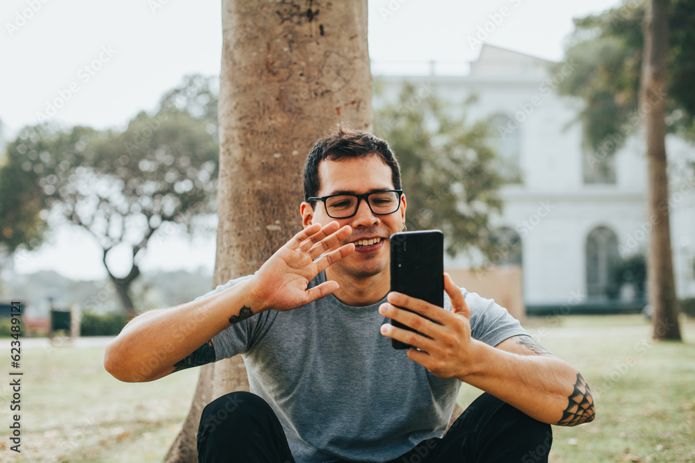 Portrait photography of a young man in video call from his phone ...
