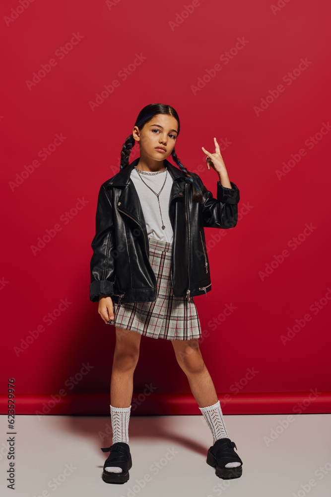 Full length of fashionable preteen girl with hairstyle wearing leather ...