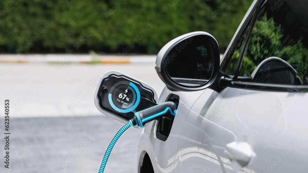 Electric car recharge with EV charger at futuristic car park ...