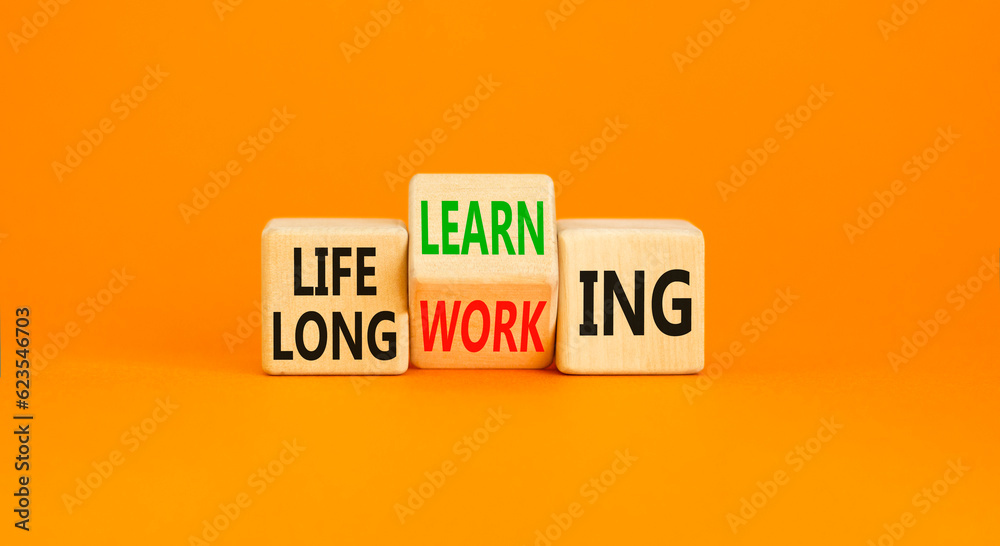 Lifelong learning working symbol. Concept word Lifelong learning working on block on a beautiful ...