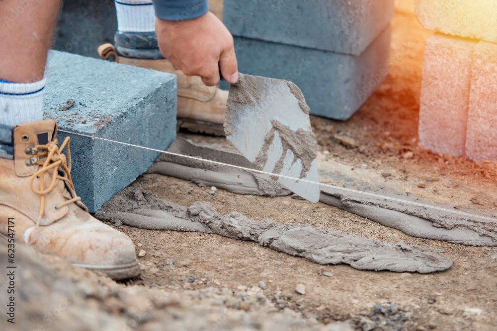 Bricklayer laying high-density footing concrete blocks Stock Photo ...