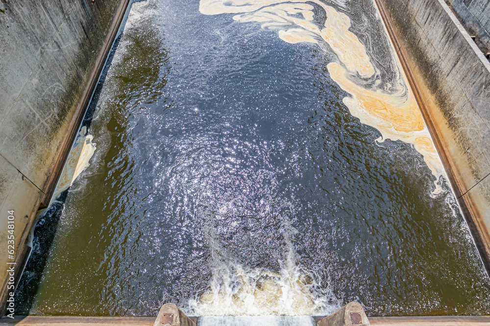 Water flowing from gate of Staumauer Bitburger dam into Prum rive ...