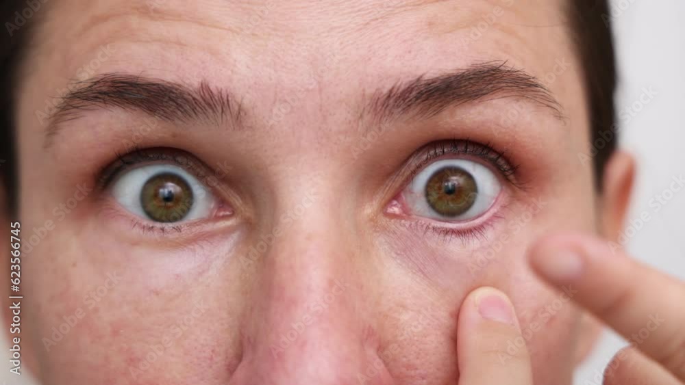 millennial woman put or remove contact lens.female pouring solution dry ...