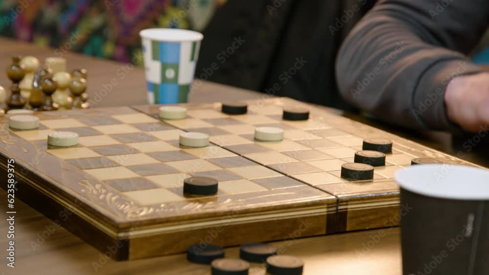 Wooden chessboard during the game. Checkers. The movement of the white ...