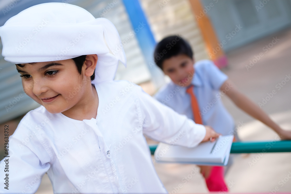 Arabic student boy at school playing with classmates during break lunch ...