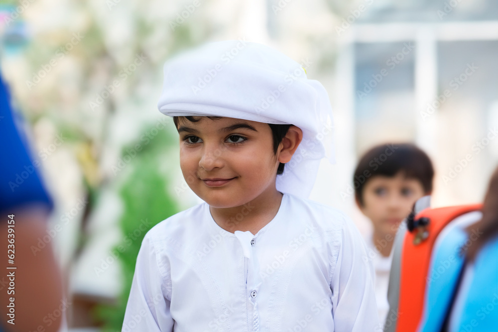Boy in Kandura at school Young Arab student with classmates waiting in ...