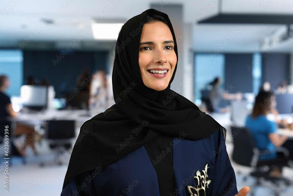 Emiratisation concept of woman at office working with colleagues. Local ...