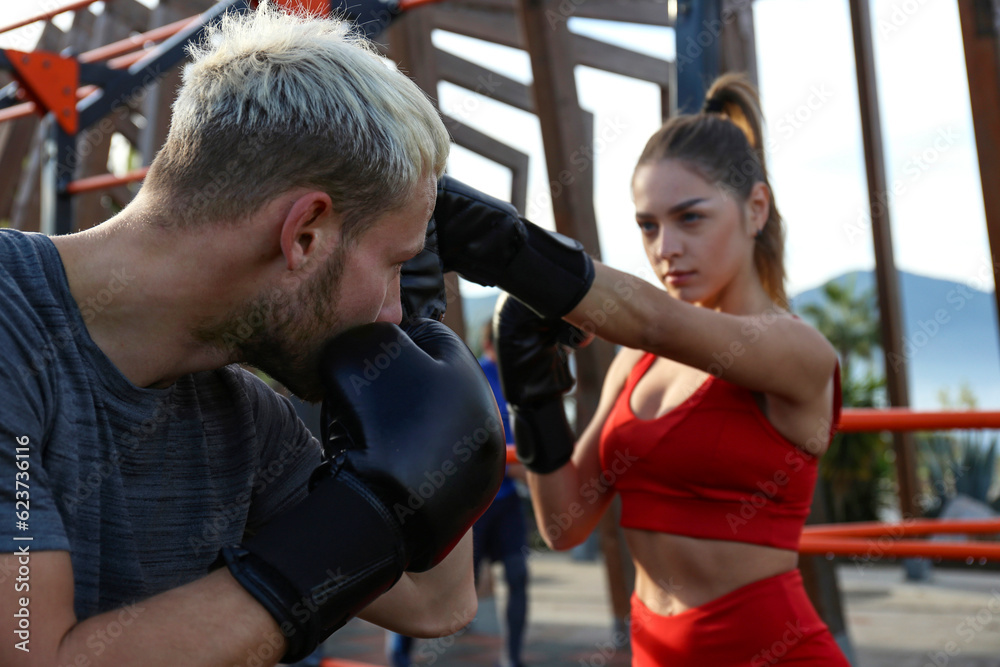 Foto de Young woman training with her personal striking coach at an ...