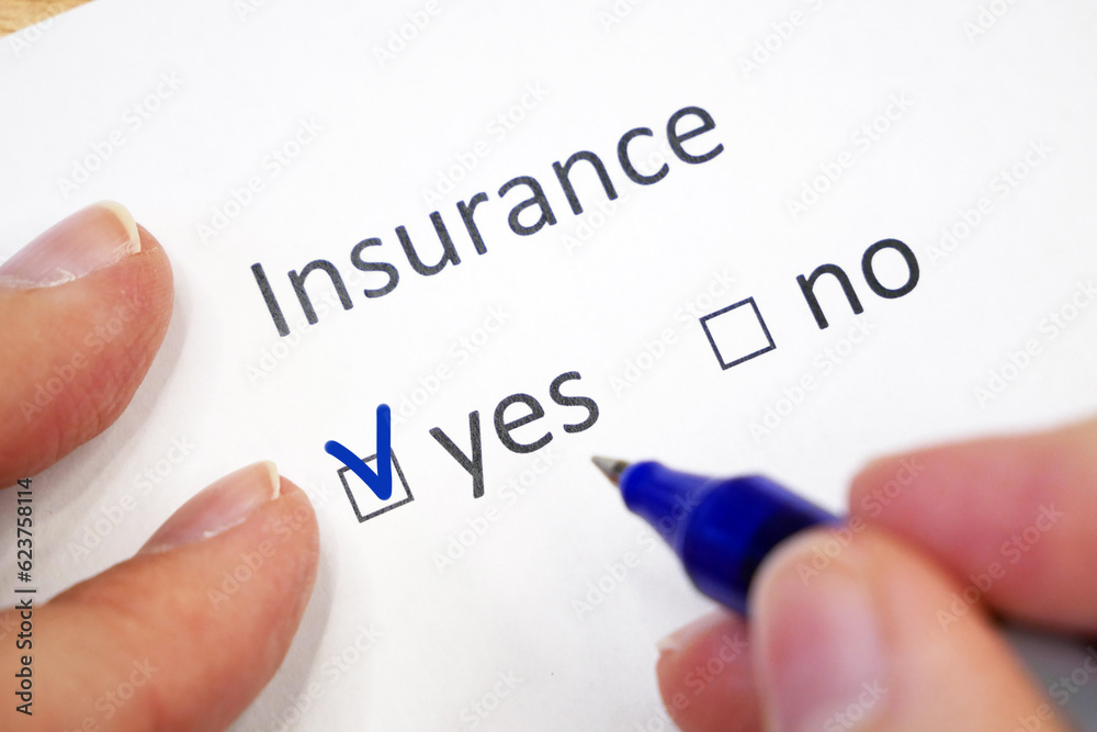 female hand fills out a questionnaire with check-box - insured yes or ...