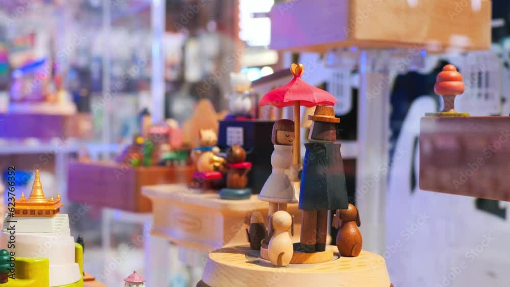 Spinning wooden toys on a storefront. Cinematic video of music box ...