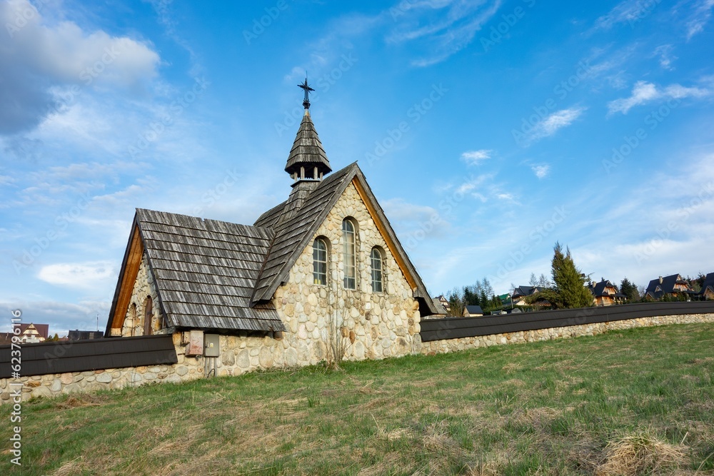 Small stone chapel with a cross on a roof in Murzasichle graveyard in ...