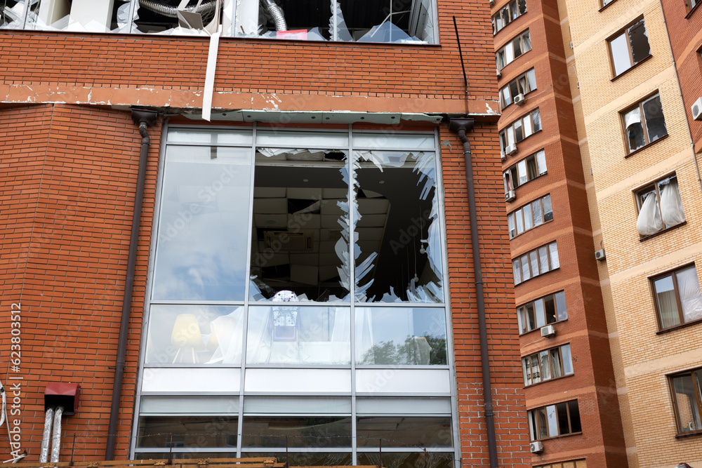 Broken windows of civilian building of bomb explosion. Shards of glass ...