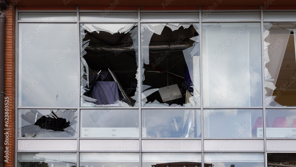 Broken windows of civilian building of bomb explosion. Shards of glass ...