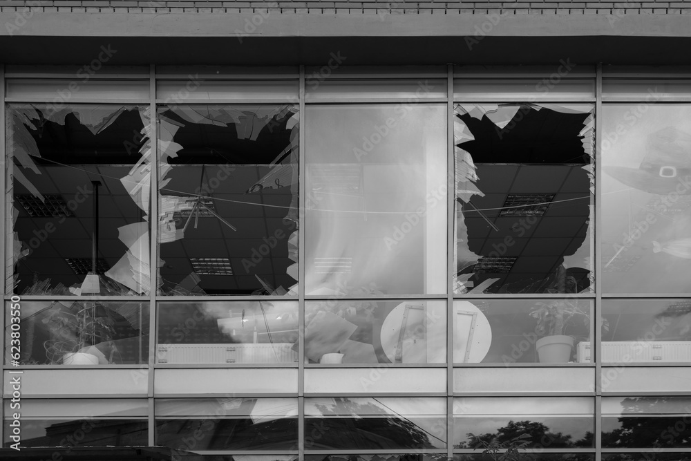 Broken windows of civilian building of bomb explosion. Shards of glass ...