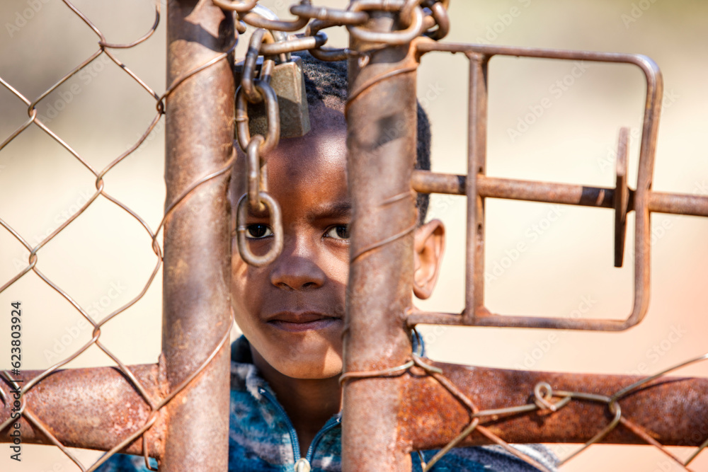 peeping village african child behind the locked gate Stock Photo ...