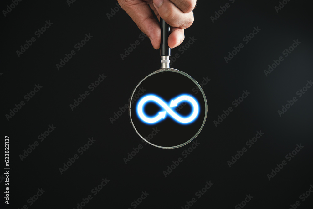 Magnifying glass zooms in on infinity symbol icons, signifying future ...
