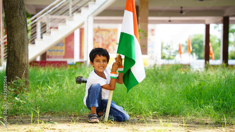 Cute little boy holding Indian flag in his hands and smiling ...