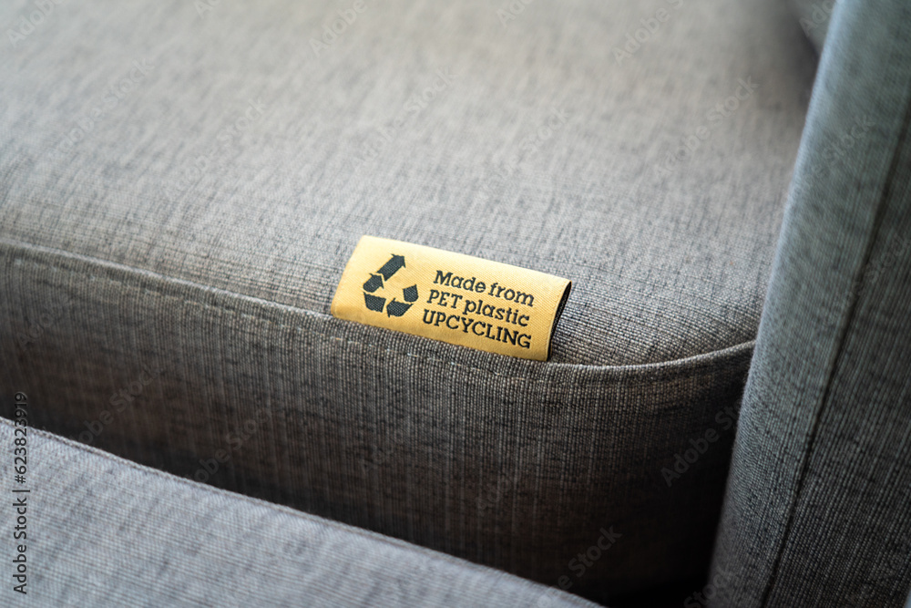 "PET Plastic upcycling" product label tag on the sofa seat fabric ...