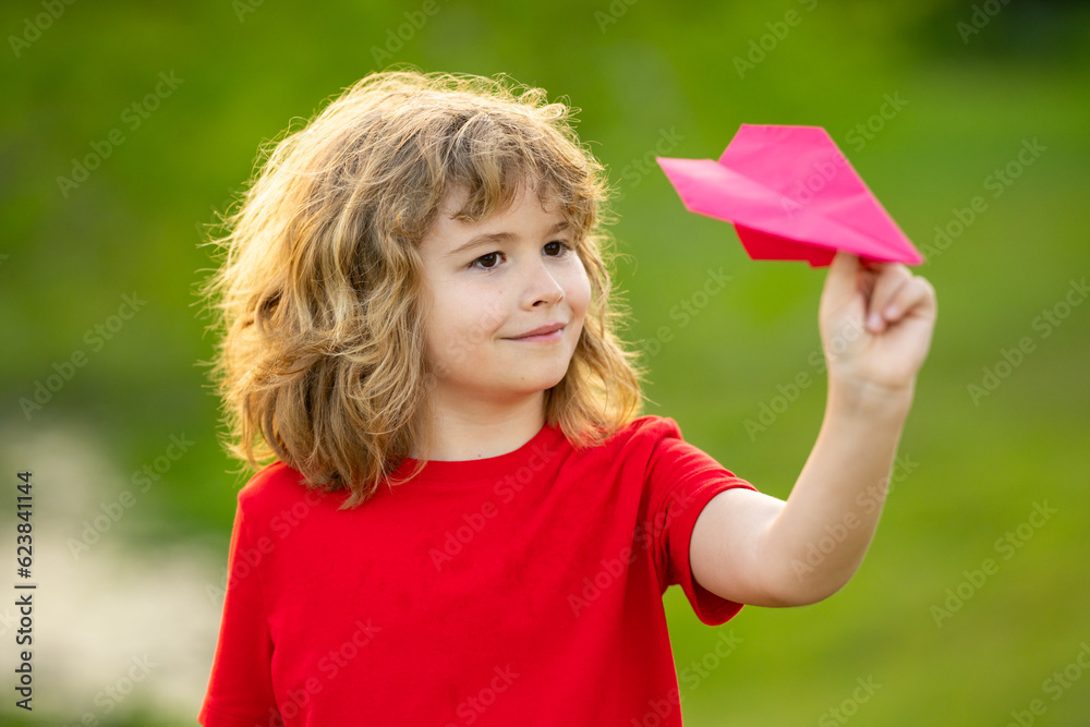 Child playing with paper airplane. Cute child throwing paper plane in ...