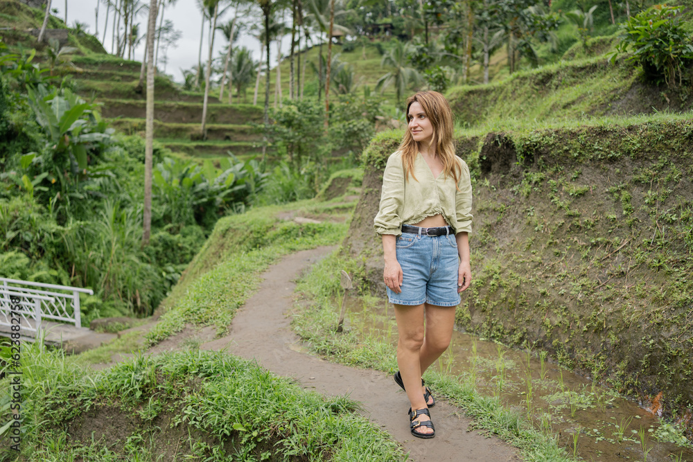 woman travelling in Asia, walking in rice paddies in Bali, freedom ...