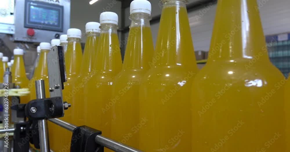 Bottling lemonade at the factory. Production of beverages - carbonated ...