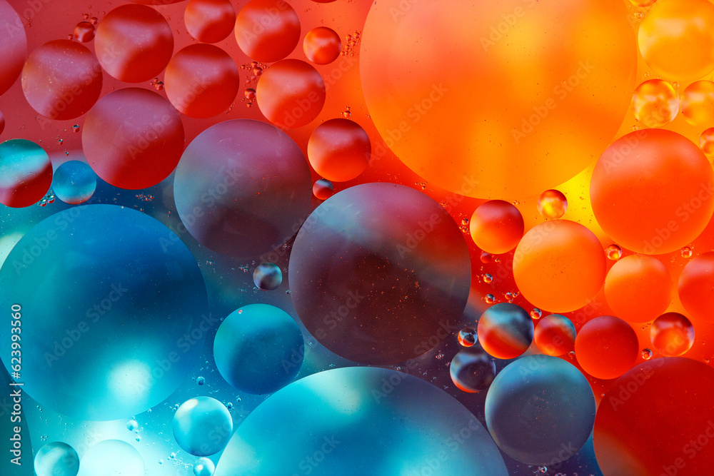 Oil spheres in the water, close-up macro shot in front of a multi ...