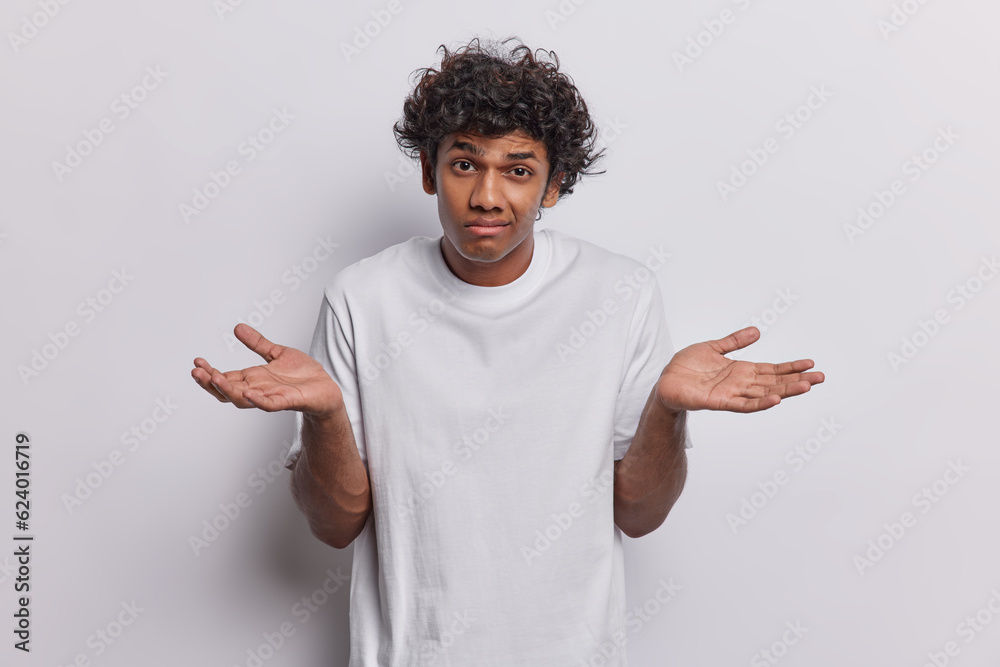 People emotions. Young Hindu guy wearing white casual tshirt standing ...
