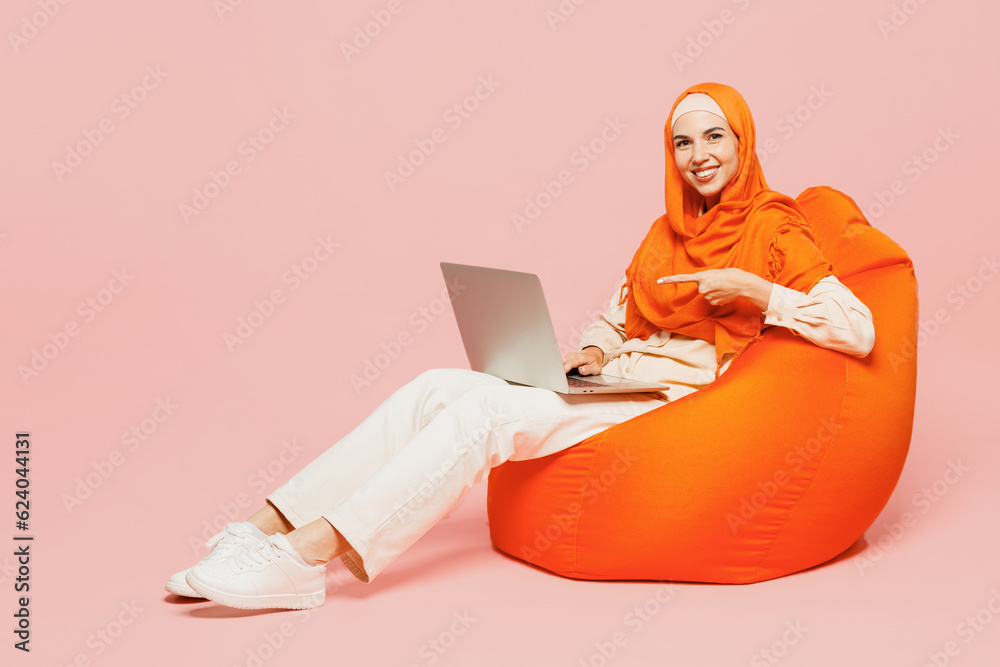 Full body young arabian asian muslim IT woman wear abaya hijab sit in ...
